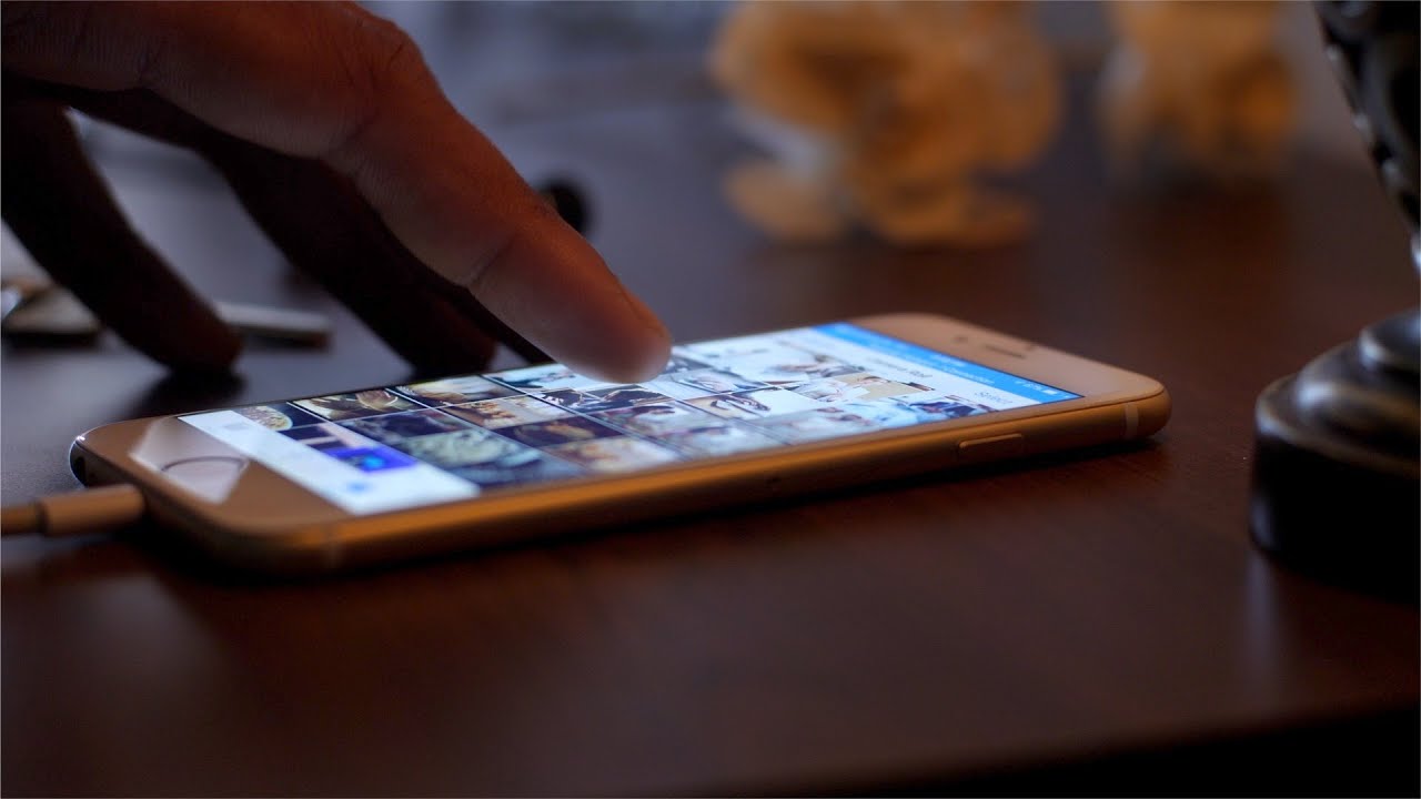 Shot of a man scrolling images on his smartphone | Indian Stock Footage ...