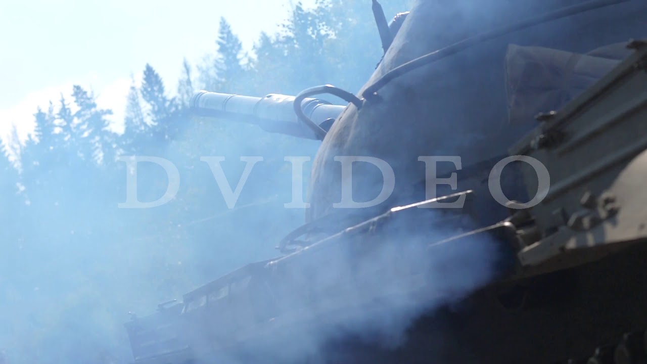 Smoke from military tank standing on war field. Military vehicle on ...
