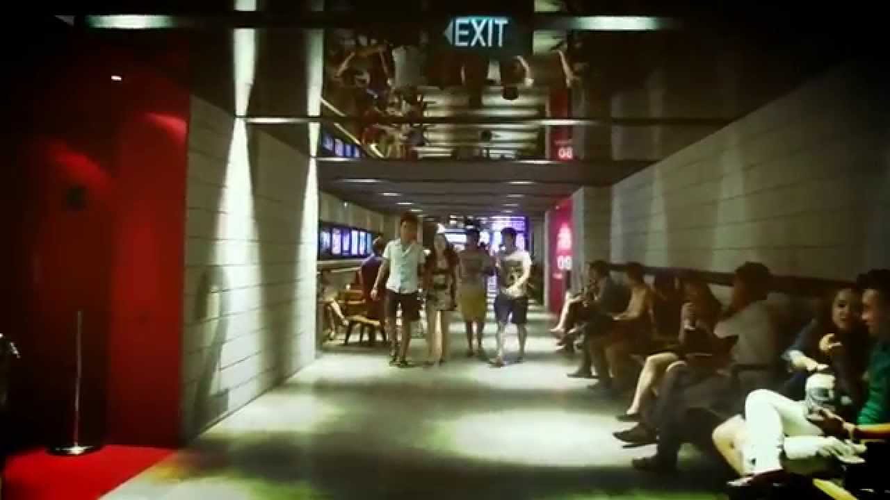Guys walking inside the cinema with reflection on the ceiling - YouTube