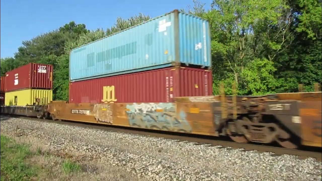 CN 8808, 5704 speed a Westbound intermodal container in well car freight train past Vicksburg ...