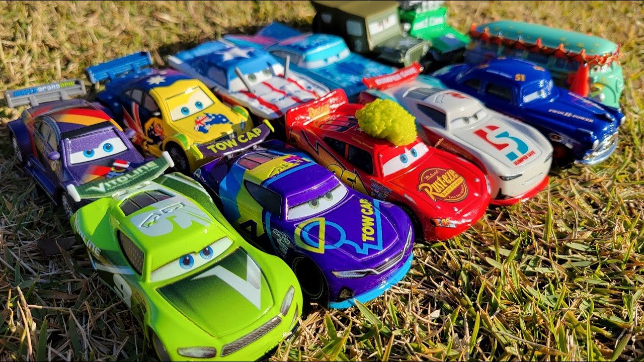 Twelve a little big matel cars (minicars) are lurking in a plaza with a ...