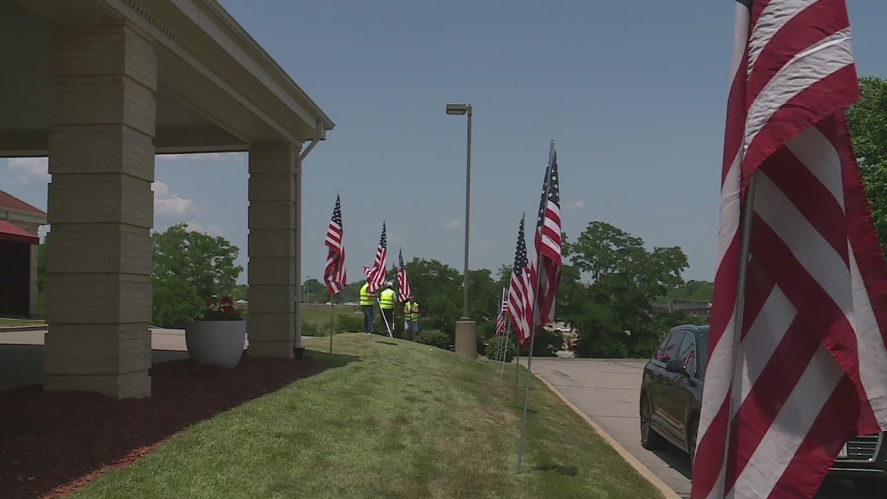 Local group displays hundreds of flags to honor fallen marine - YouTube
