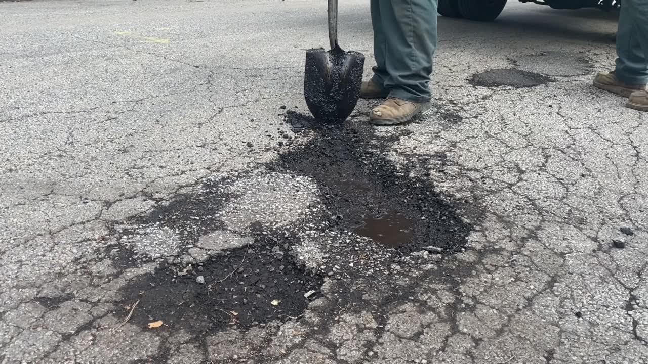 Public Works staff members demonstrate how to fill potholes in Carlisle ...