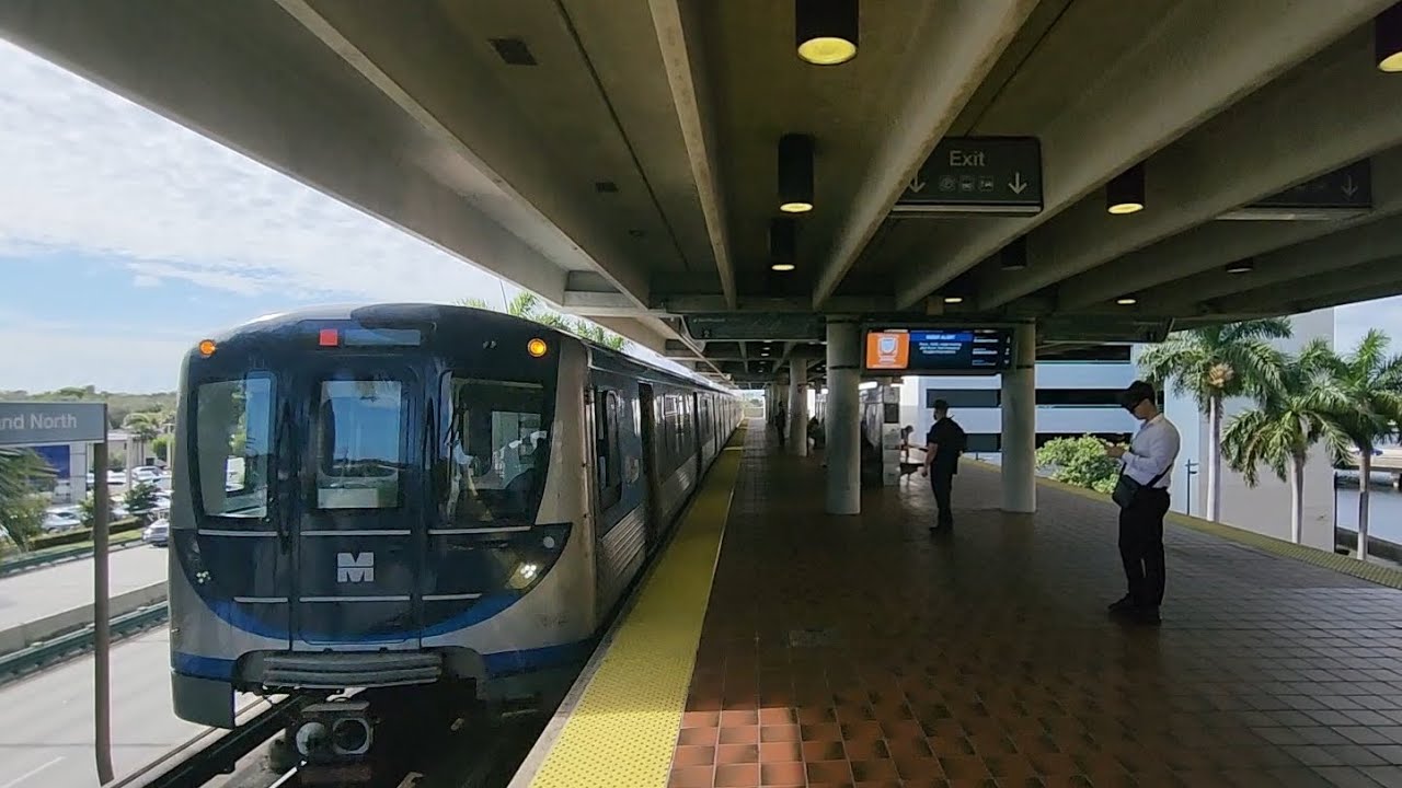 Miami Metrorail Northbound Orange Line train arriving and departing at ...