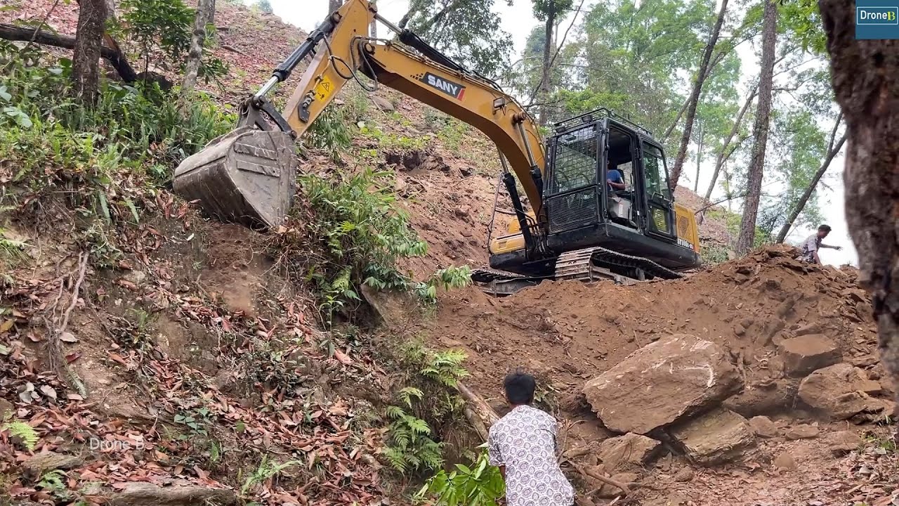 Mini Excavator Cutting Hillside with Rocks, Boulders, and Trees ...