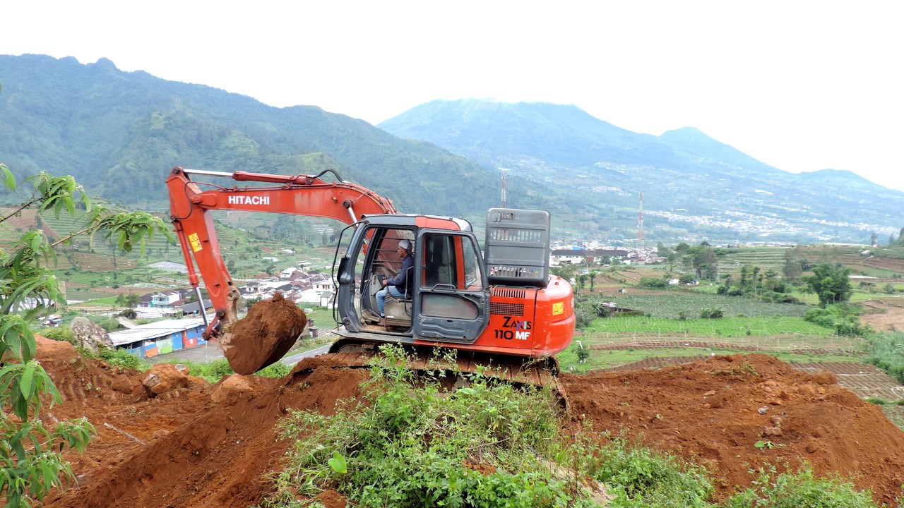 Excavator digging the ground with beautiful mountain view - YouTube