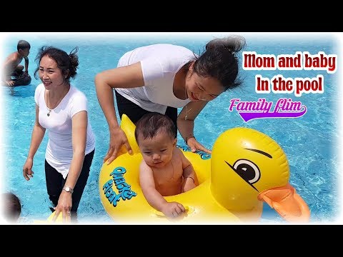 Mom and lovely baby in the pool