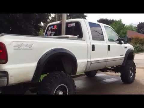 F250 lifted 14” with 38” tires smoke stack and flat cover - YouTube