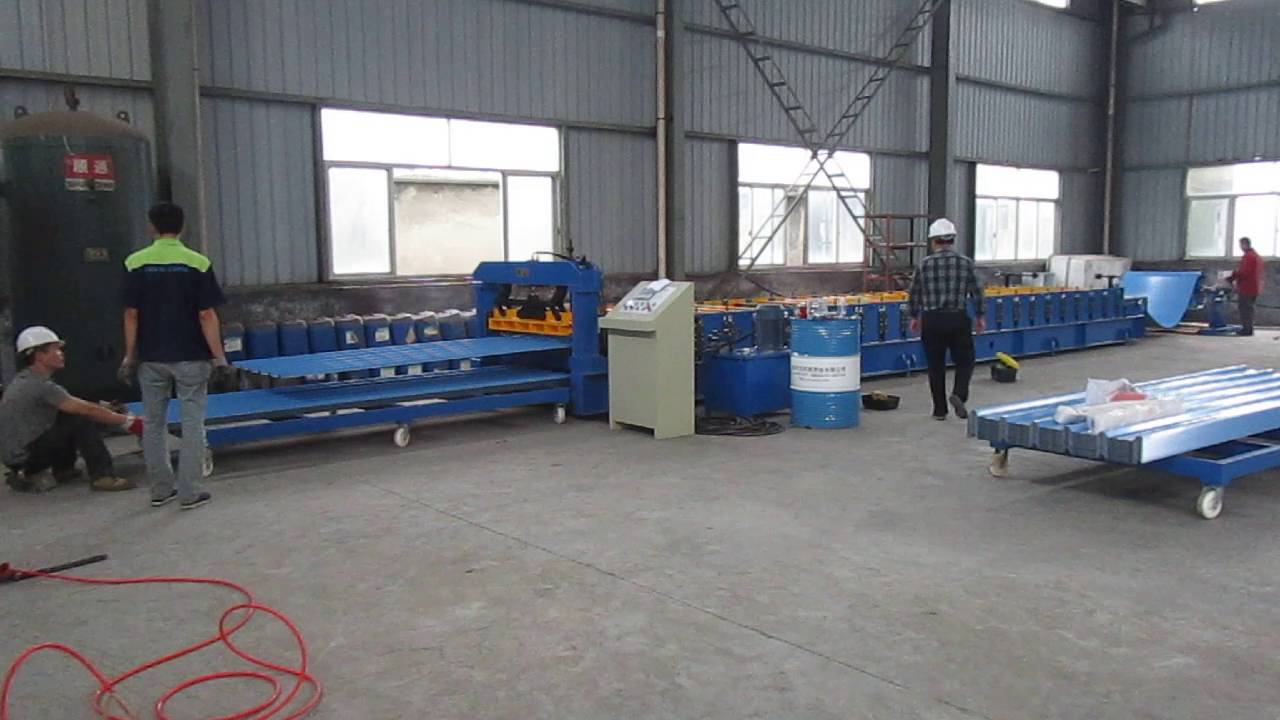 Two workers to operate roll forming machine with manual decoiler - YouTube