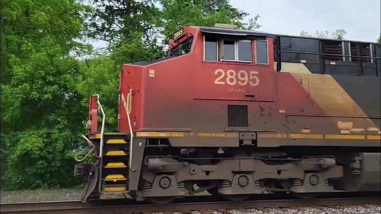 CN 2895, 3966 Westbound freight train with a TRAILER TRAIN center beam flat car at Vicksburg, MI ...