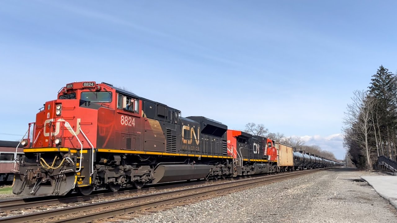 A CN SD70M-2 leads a Tank train through Chesterton with a friendly ...