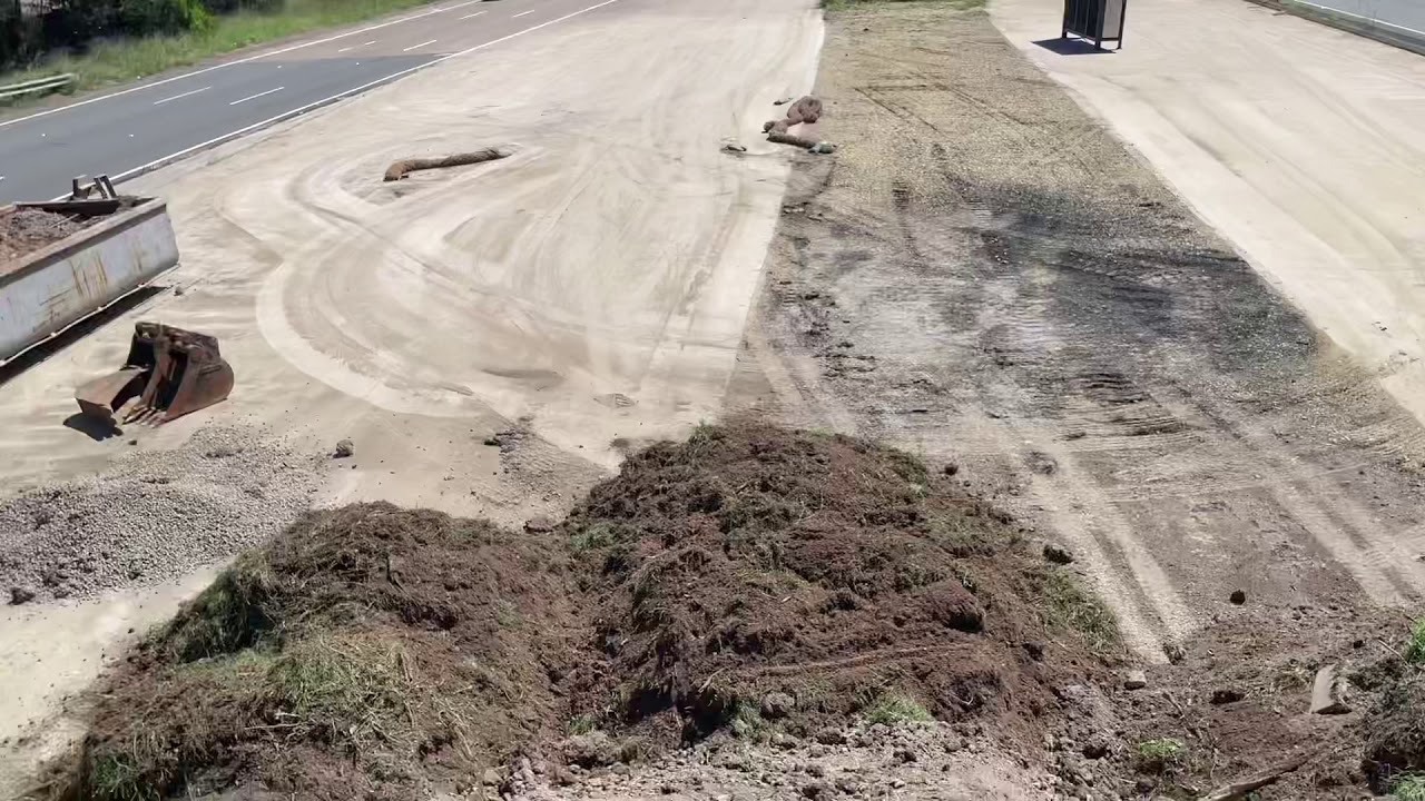 Digger driver digging dirt - stockpile clean up in Australia - YouTube