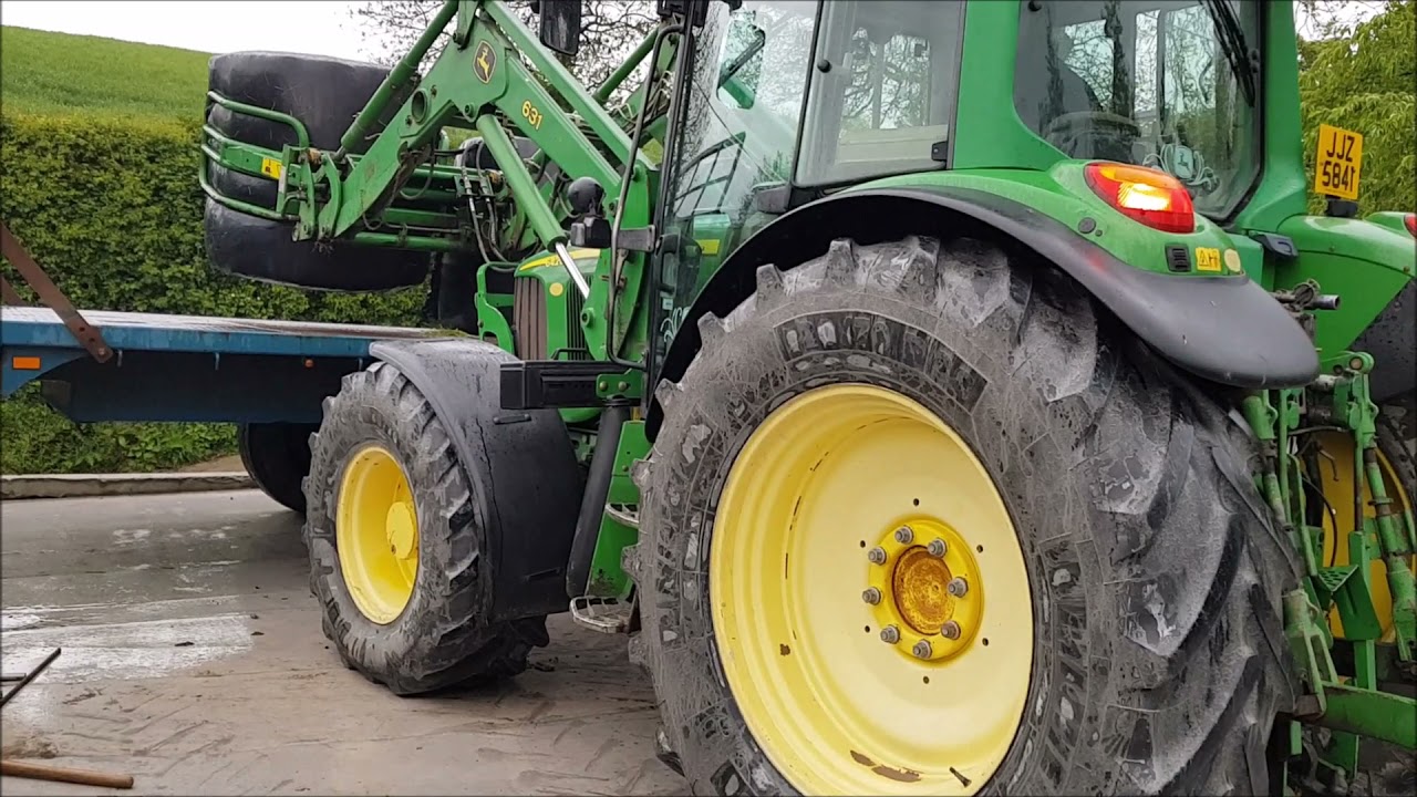 stacking round bales with John Deere tractor - YouTube