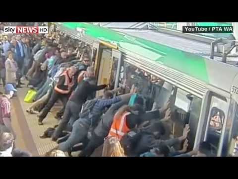 Commuters Push Train Off Trapped Passenger - YouTube