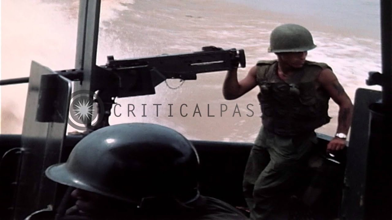 A machine gunner stands by his machine gun aboard a PBR and fires it in ...