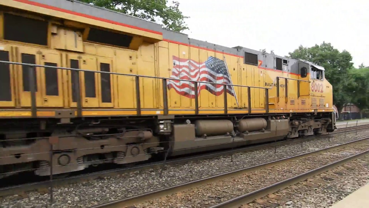 UP 8002 leads a coal train with UP 8176 as a DPU meets a inbound Amtrak ...