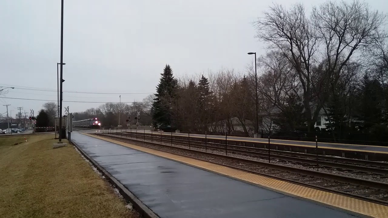 Metra 144 leads an outbound Metra past Dee Road - YouTube