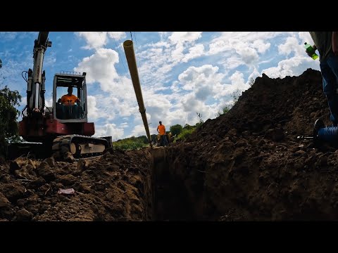 4 inch water main ditch crossing with 10 inch casing pipe - YouTube
