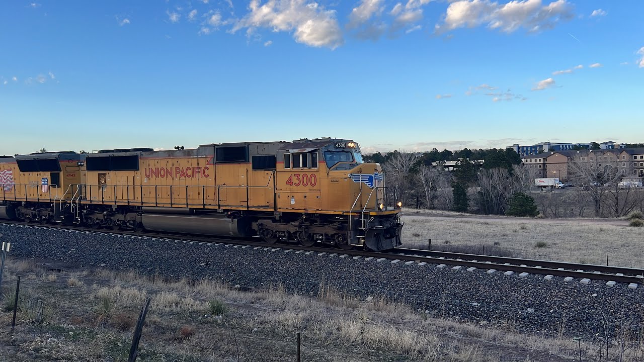 UP 4300 LEADS AN EMPTY WELDED RAIL TRAIN! - YouTube