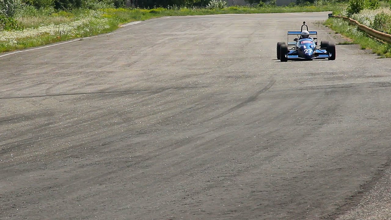 F1 racing car approaching, driver taking extremely sharp turn . Stock ...