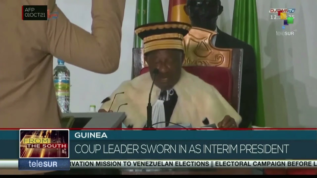 Coup leader sworn in as interim president in Guinea - YouTube