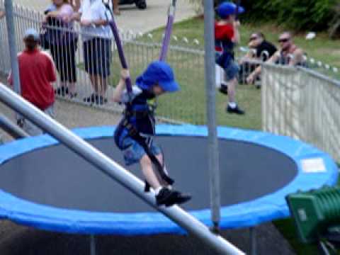 Boys jumping on bungee cord trampoline ride - YouTube