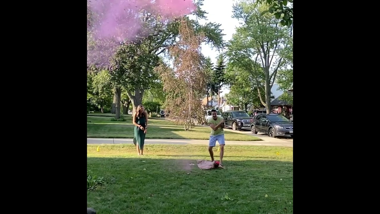 Guy and his little girl hit golf ball with club and pink dust comes out ...