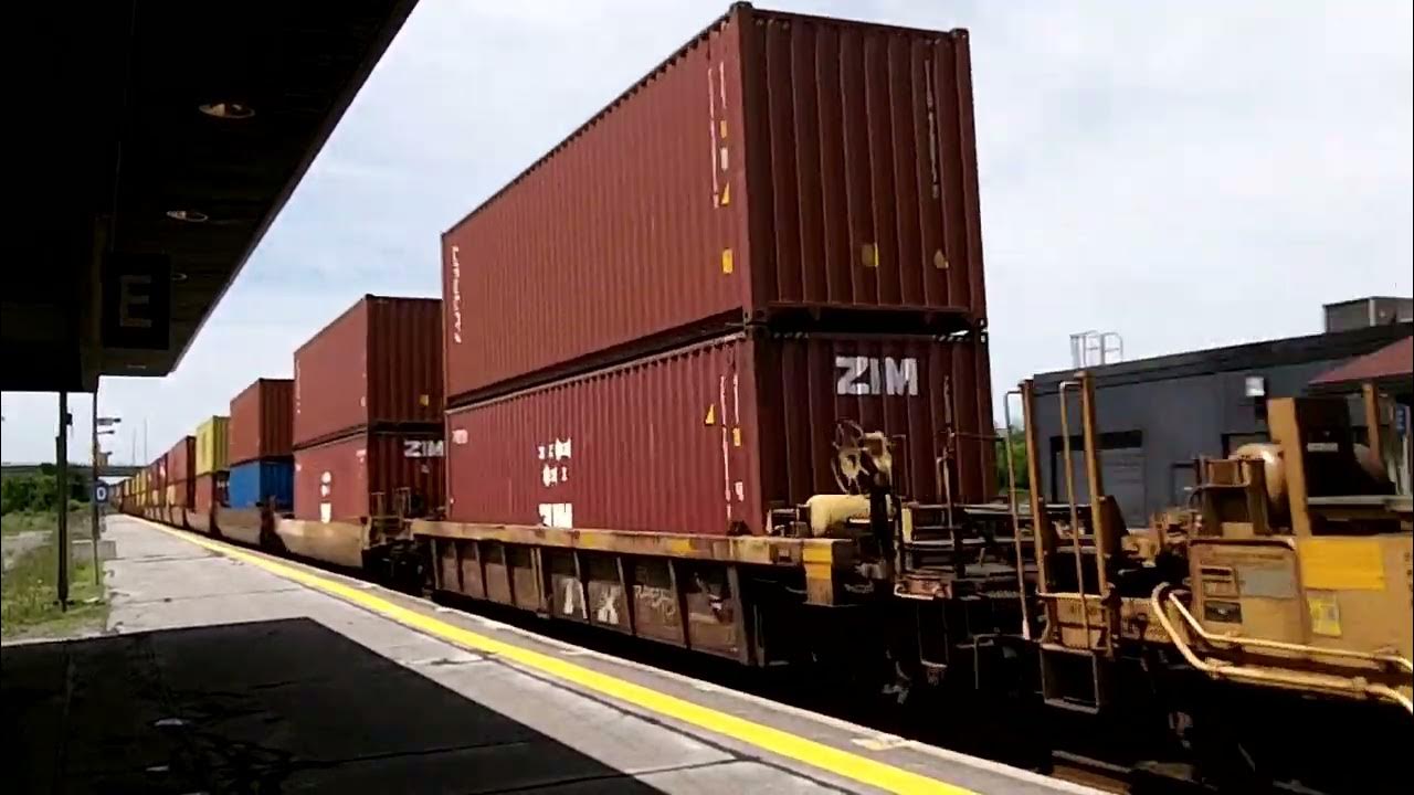 Freehand/1+1/CN 106 w/ CN 3327 (ex Dash 9 2581) leads this long EB Intermodal train by Kingston ...