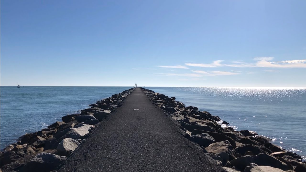 Walking on the jetty at Huntington Beach State Park - YouTube