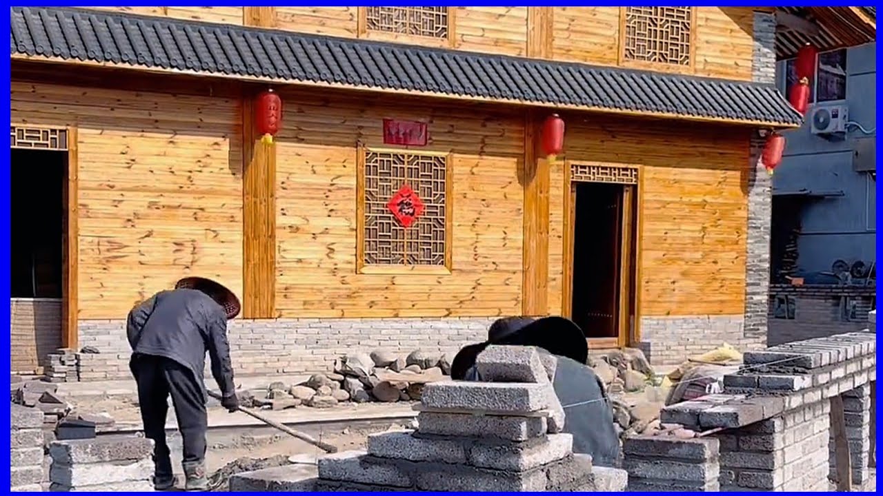 Skilled craftsman renovating an old Chinese-style house with wood ...
