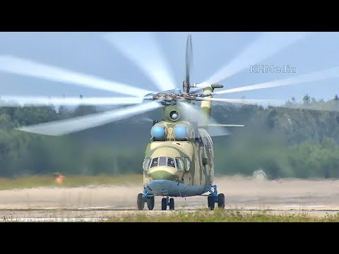 Huge Mil Mi-26 helicopter during takeoff, then pilot waves for a greeting