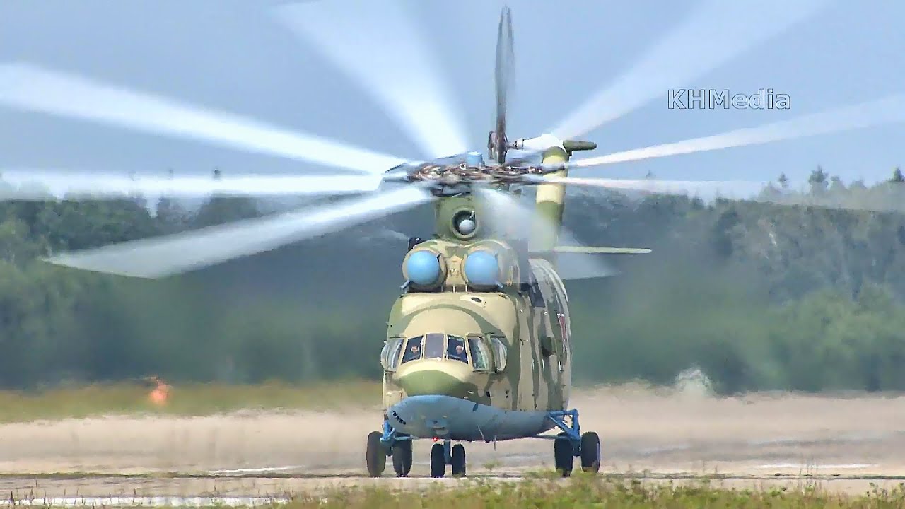 Huge Mil Mi-26 helicopter during takeoff, then pilot waves for a ...