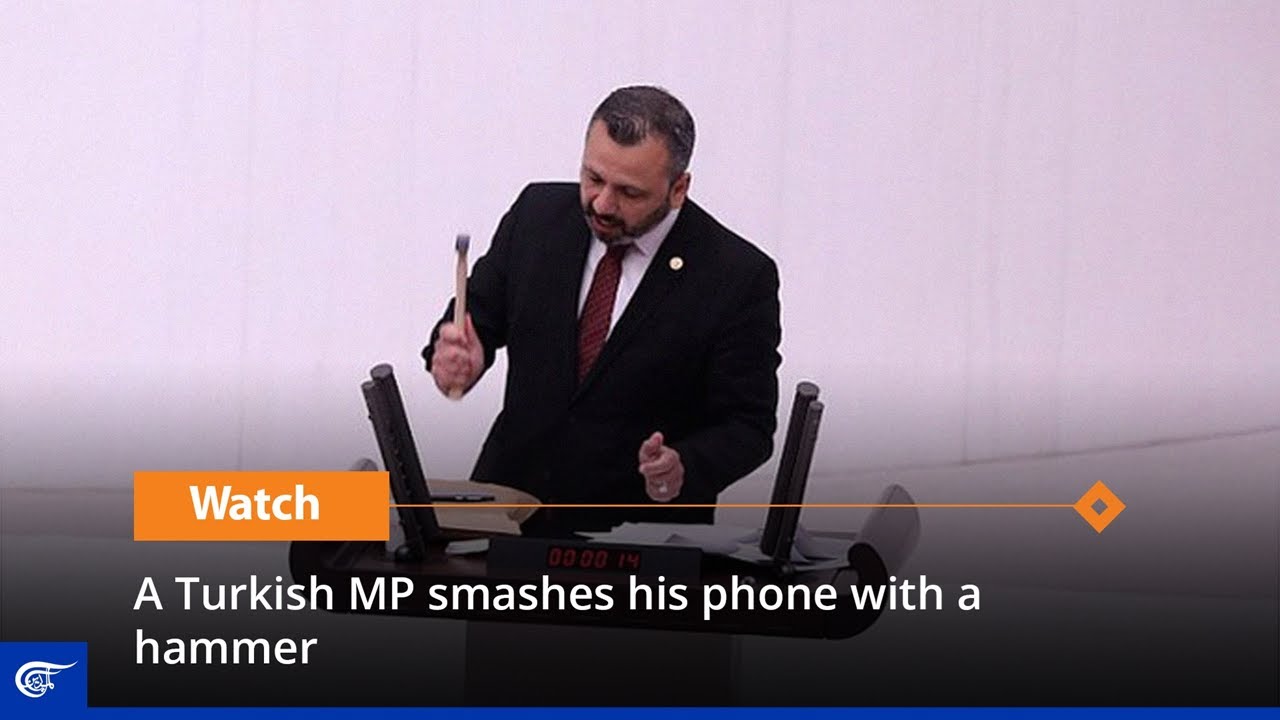 A Turkish MP smashes his phone with a hammer - YouTube