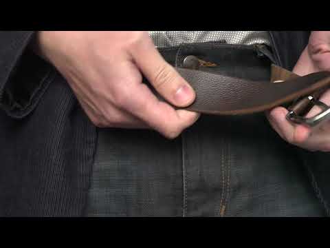 Man handles his crotch: fastens trousers and tightens jeans belt after peeing. Free HD video footage