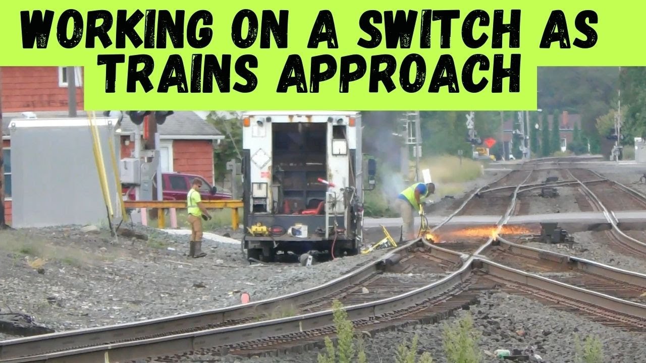 Working on a switch as trains approach the curve, Super long freight train with a DPU working ...