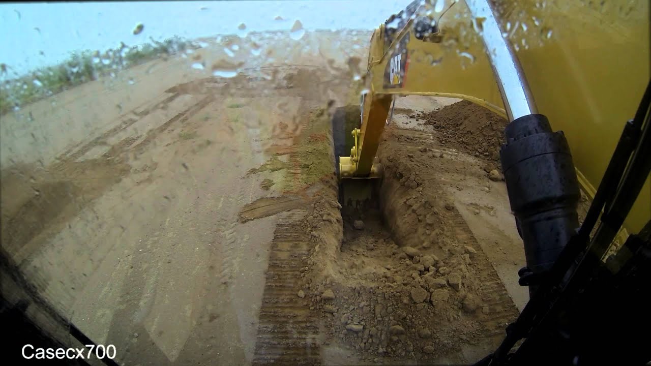 Digging in the Rain CAT 328DL - YouTube