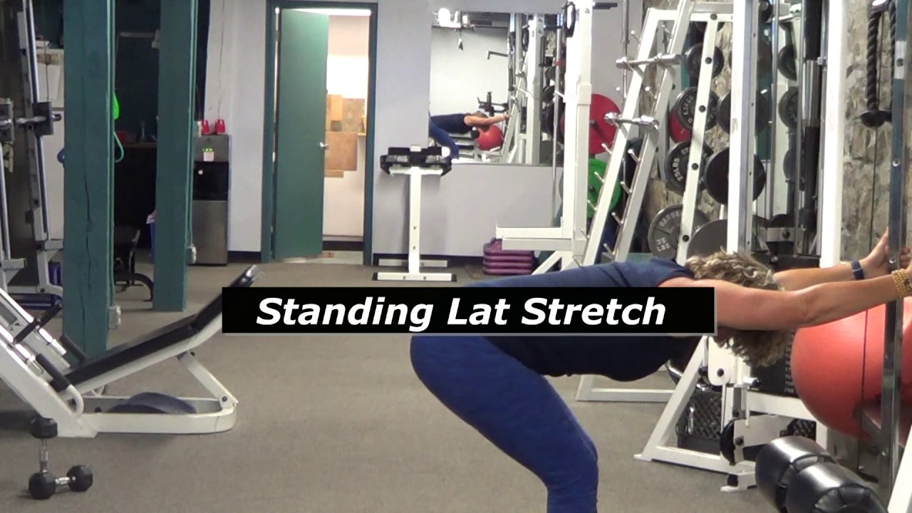 standing lat stretch - YouTube