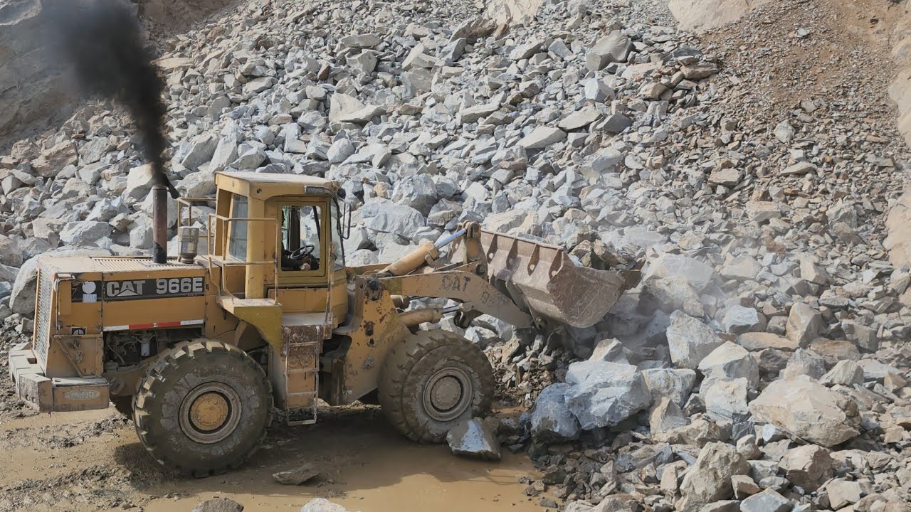 Loading Rocks into Dump Trucks With Caterpillar 966E Wheel Loader: A ...