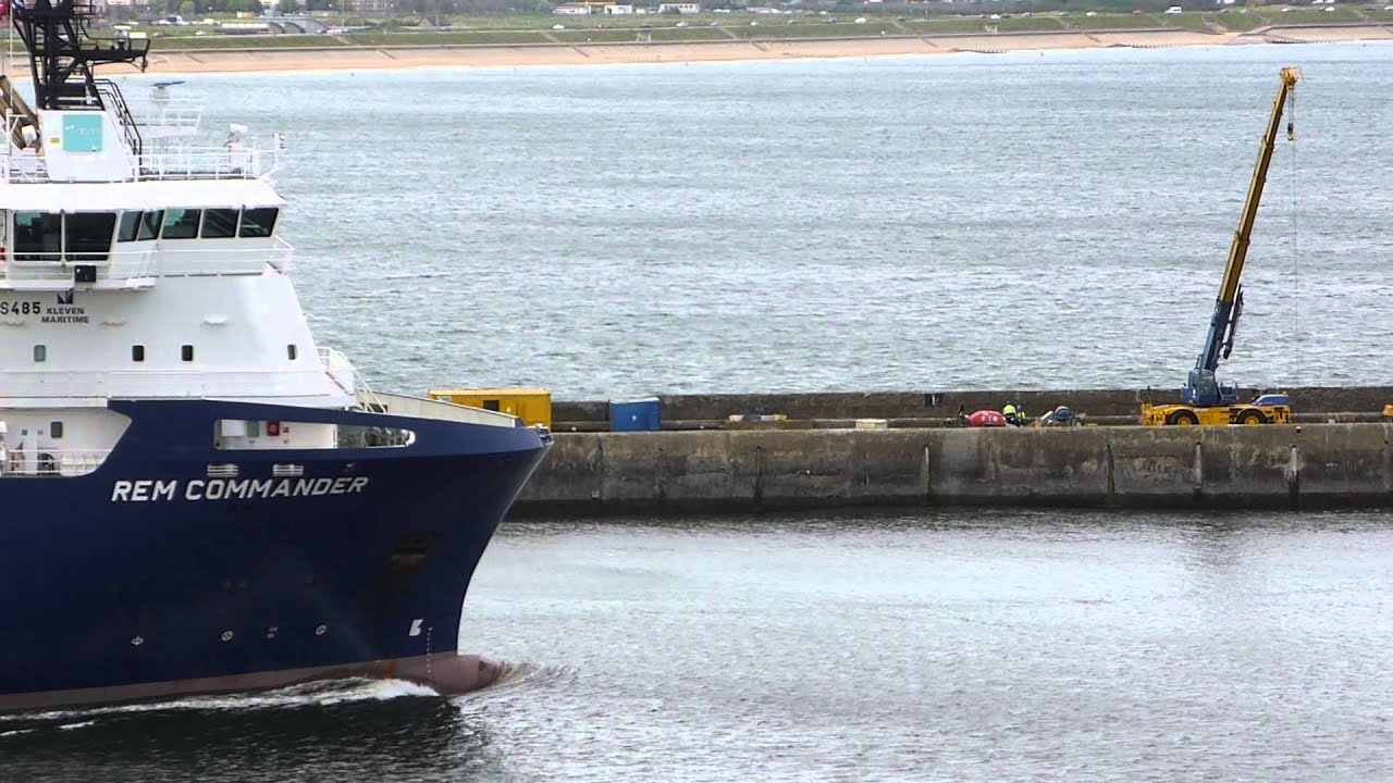 REM Commander leaving Aberdeen Harbour with dolphins jumping at bow ...