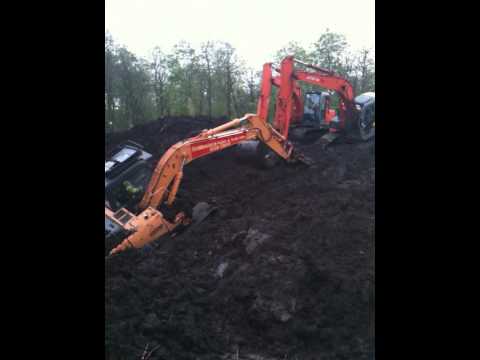 two diggers trying to pull a stuck digger out - YouTube