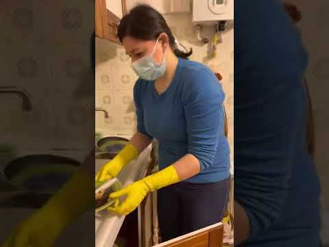 Clearing the table in rubber gloves and rain boots