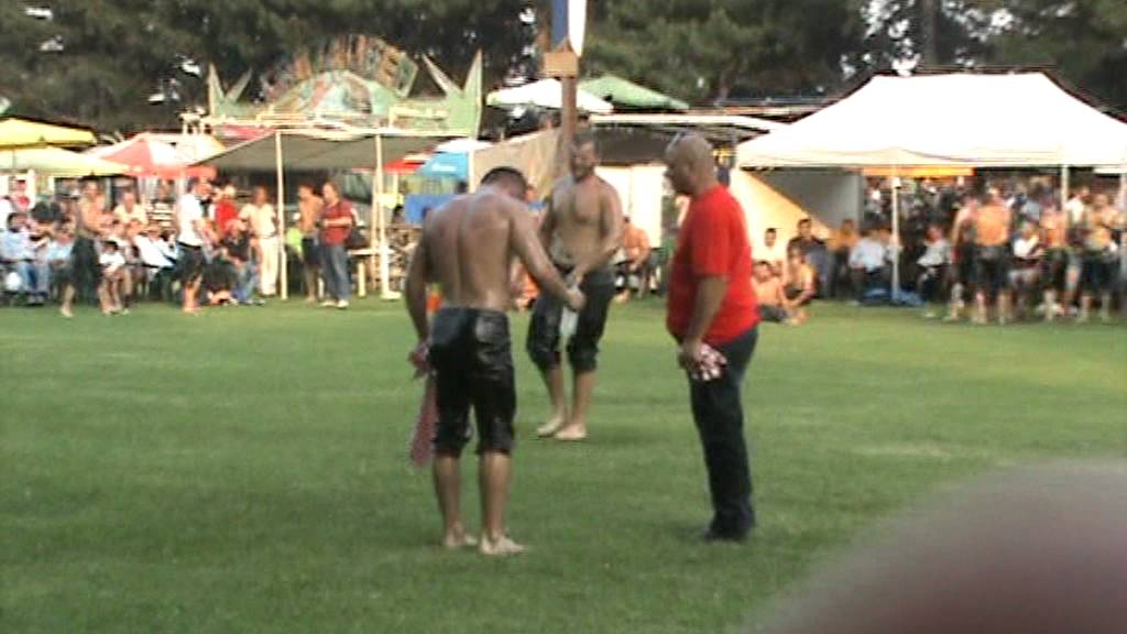 Men covered in oil wrestling event - YouTube