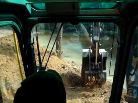 Backfilling and compacting trench - YouTube