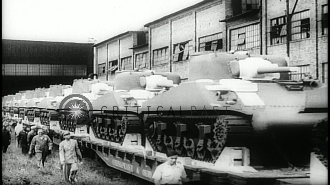 Workers work on tanks in assembly line,and tanks being taken to ...