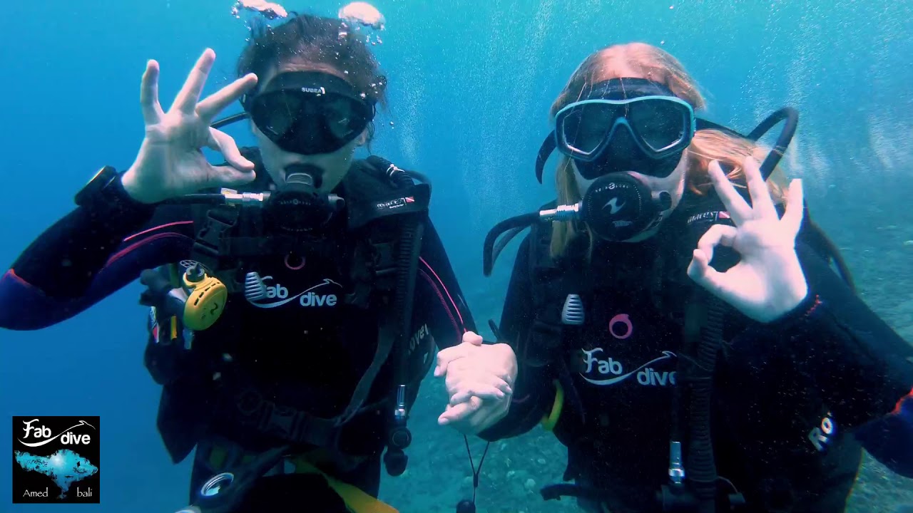 Scuba diving in Bali 2021 : two dive girls exploring the ocean in Amed ...