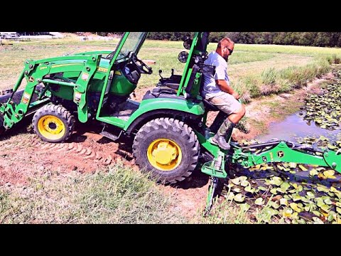 Dredging a Pond with a Tractor Backhoe - Digging Out Lily Pads - YouTube