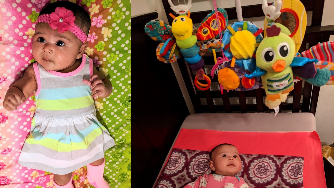 Newborn Baby has a curious look at the colorful Lamaze Toy ...