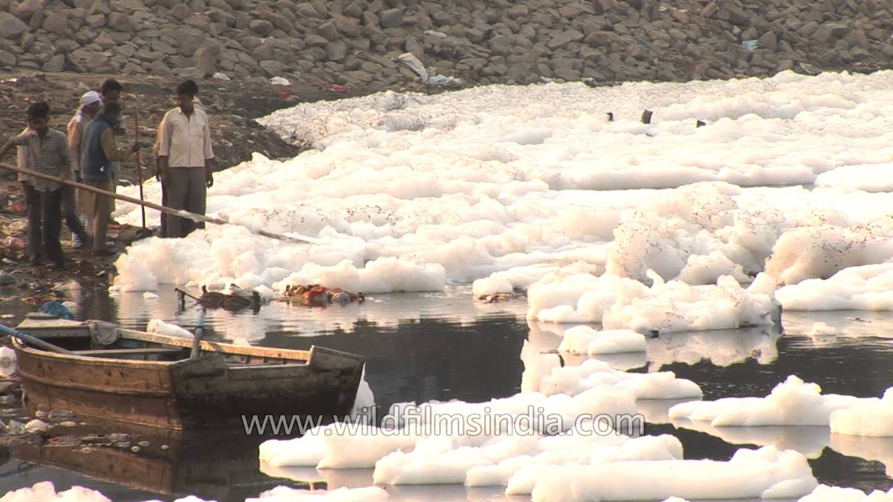 River Yamuna with froth from industrial pollution floating on surface ...
