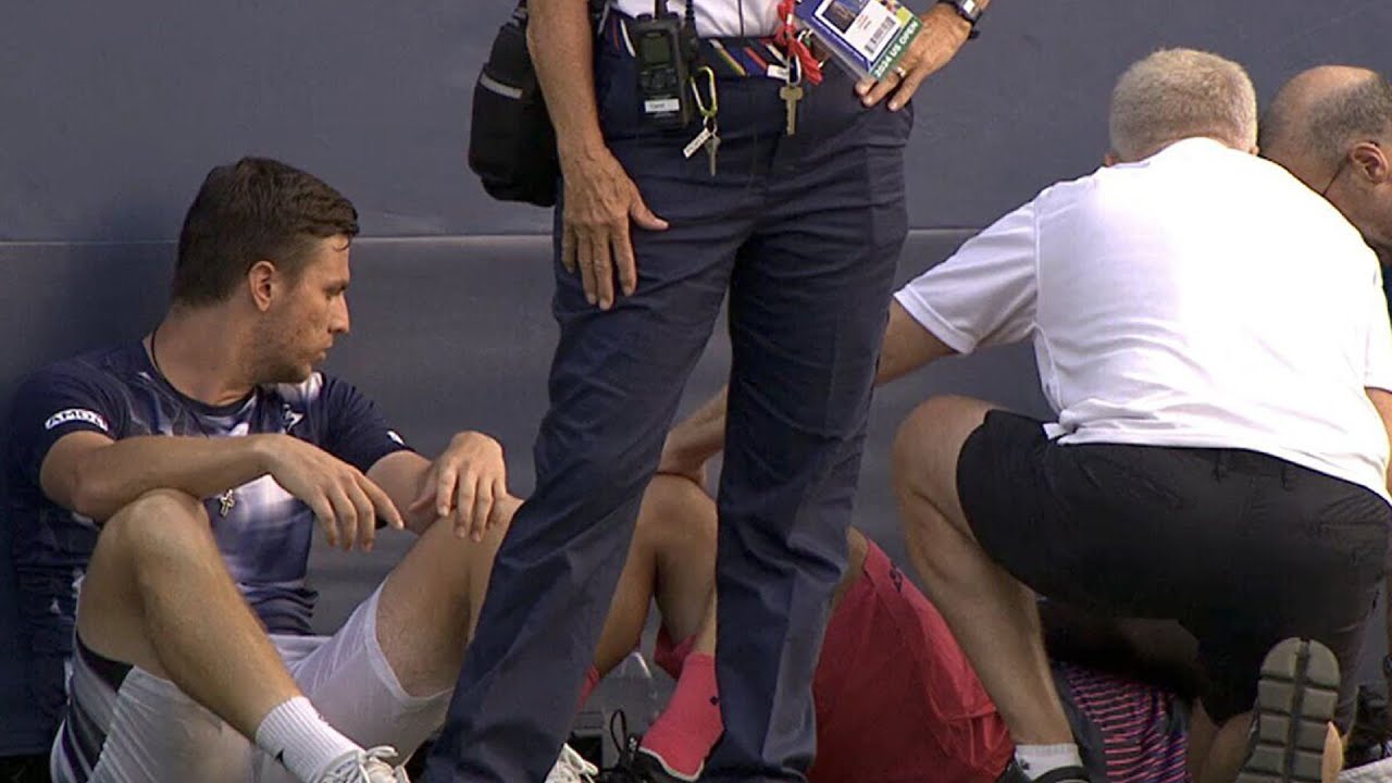 US Open star collapses to ground and retires as opponent sits by side ...