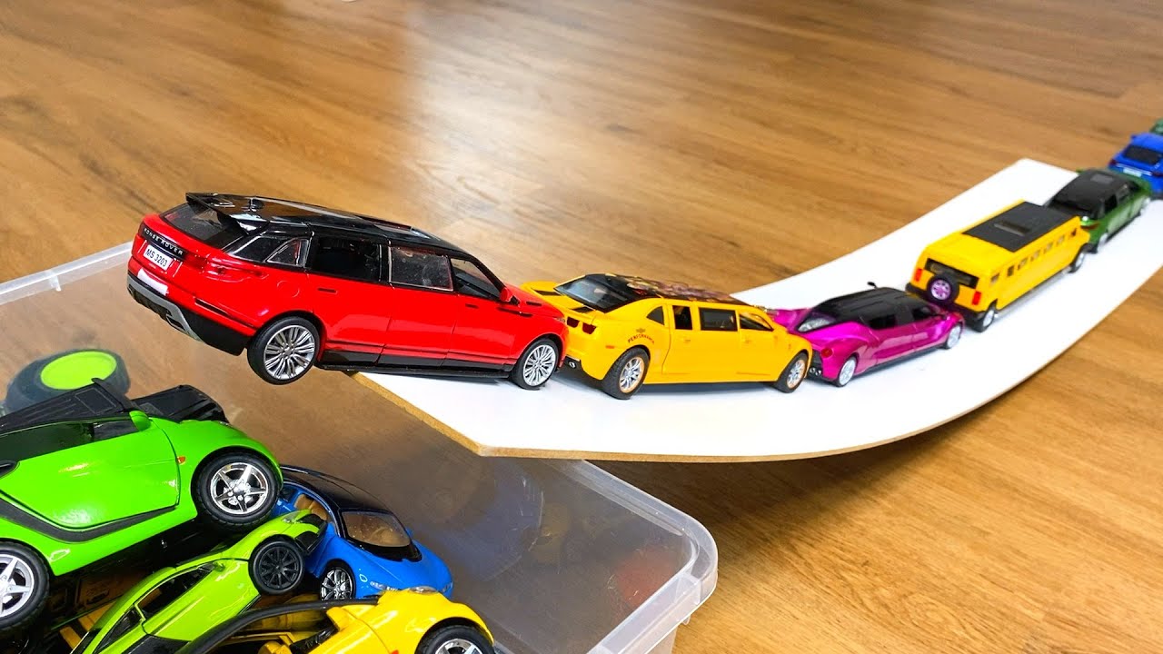 Various Bigger and Smaller Diecast Model Cars Moving Down On Slider ...